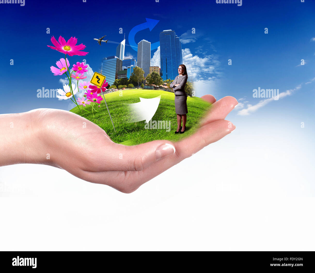 Collage with a human hand holding a green landscape Stock Photo - Alamy