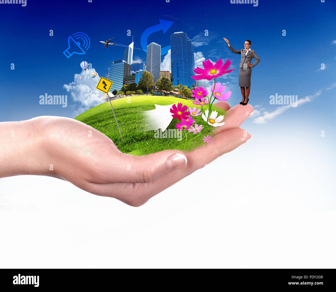 Collage with a human hand holding a green landscape Stock Photo - Alamy