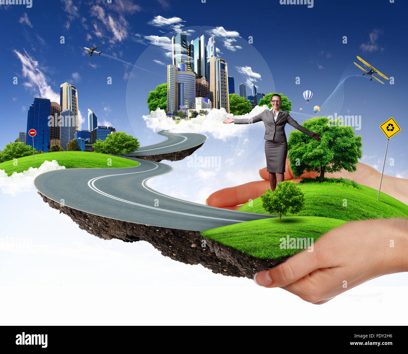 Collage with a human hand holding a green landscape Stock Photo - Alamy