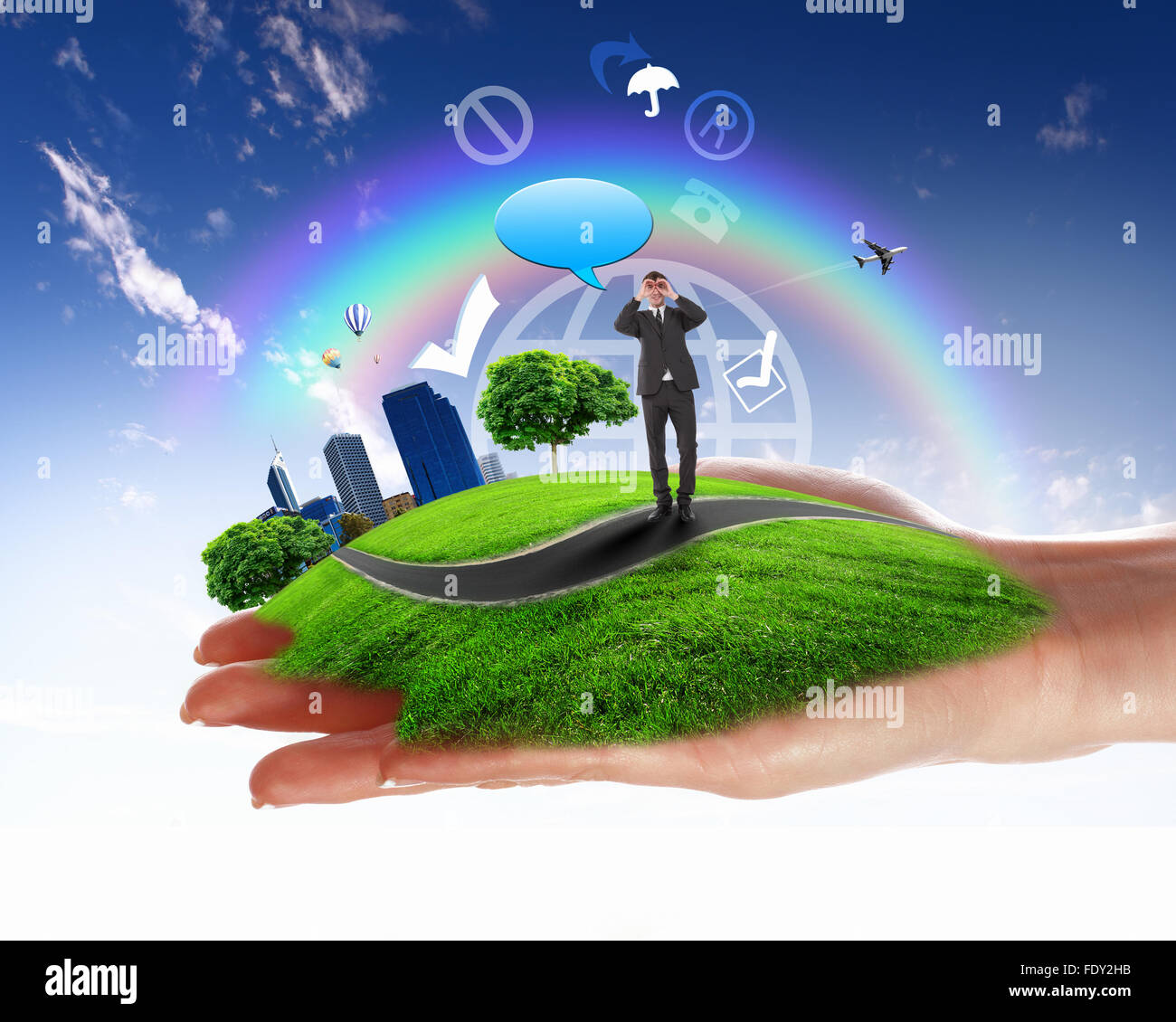 Collage with a human hand holding a green landscape Stock Photo - Alamy
