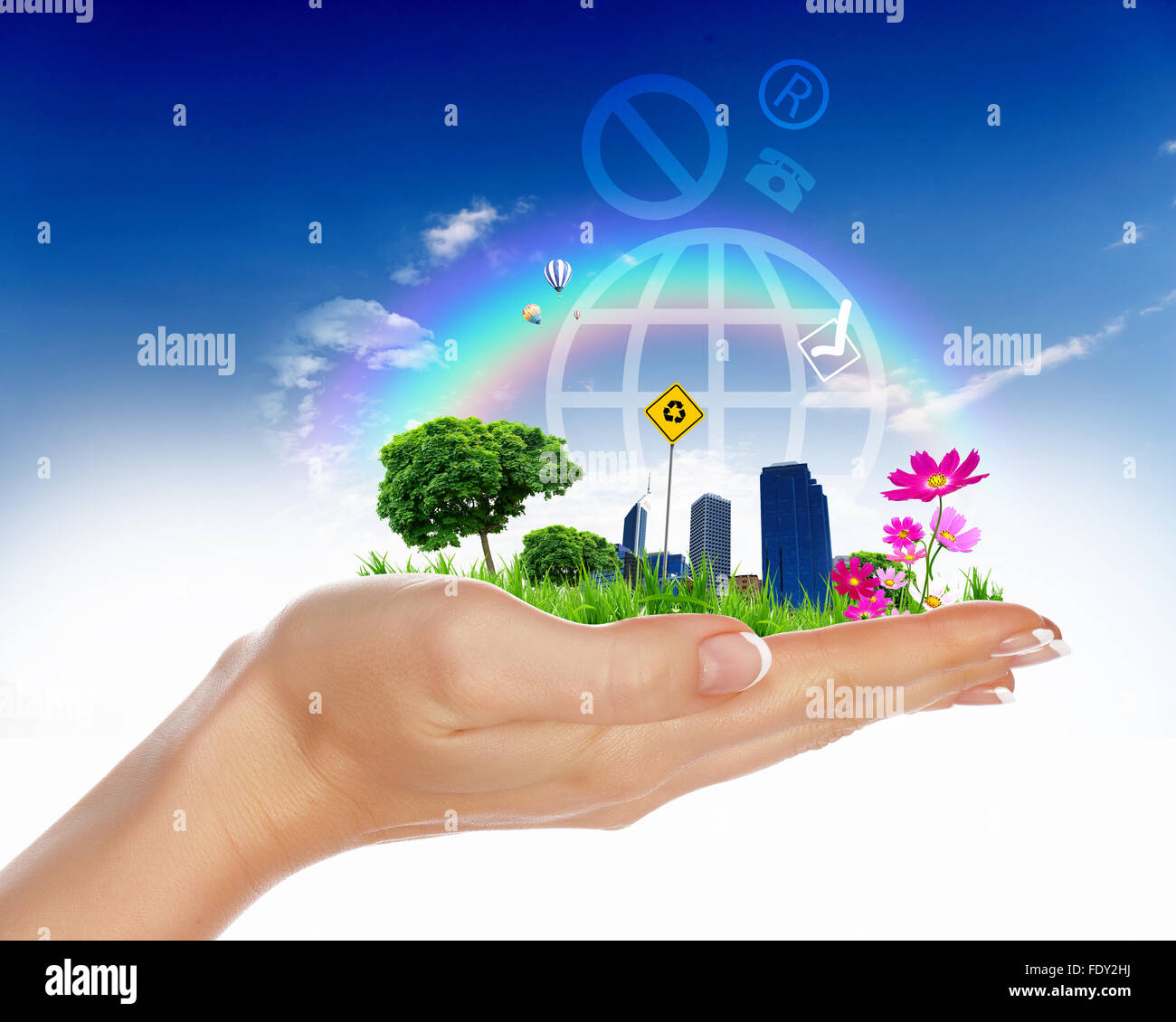 Collage with a human hand holding a green landscape Stock Photo - Alamy