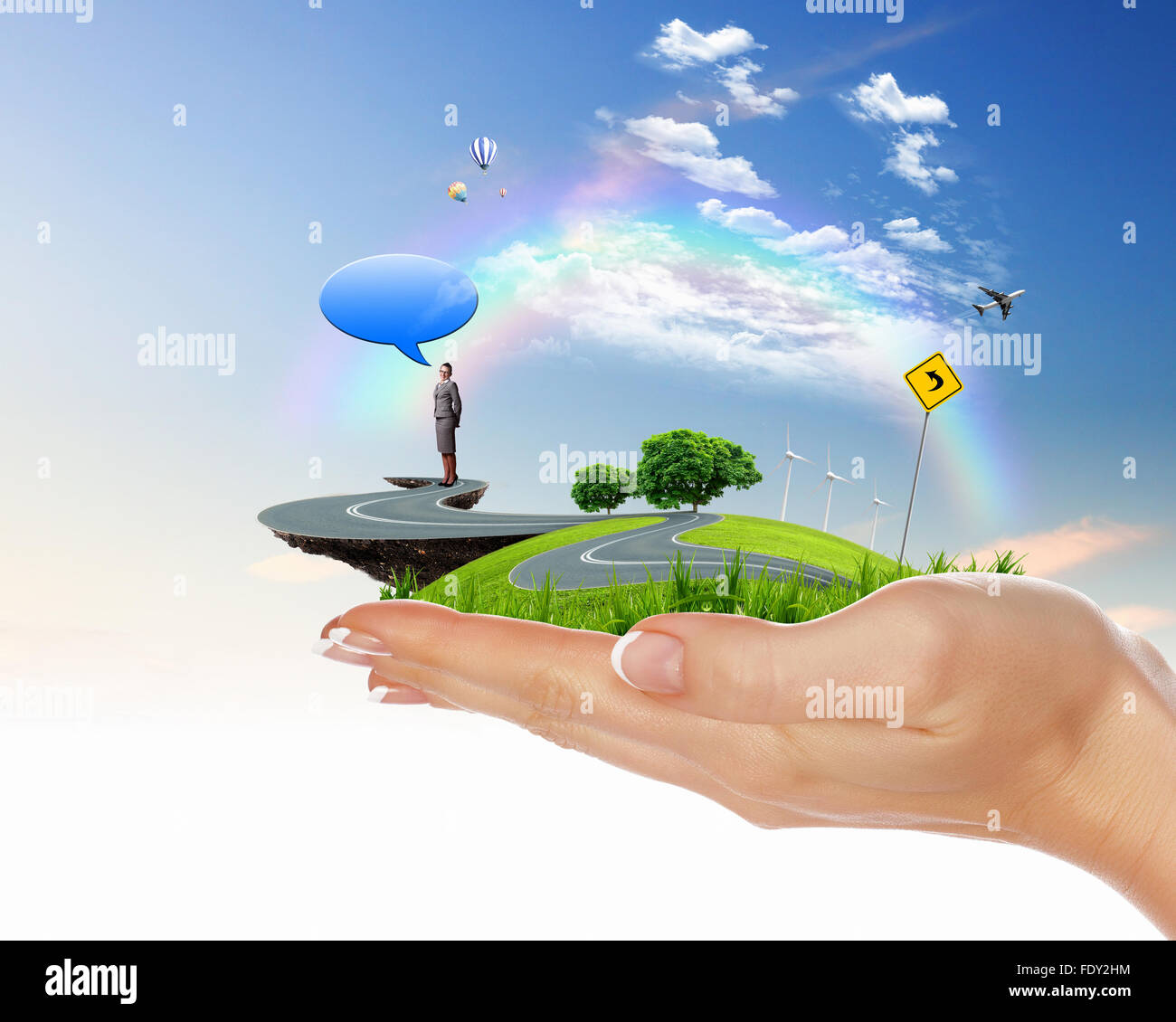 Collage with a human hand holding a green landscape Stock Photo - Alamy