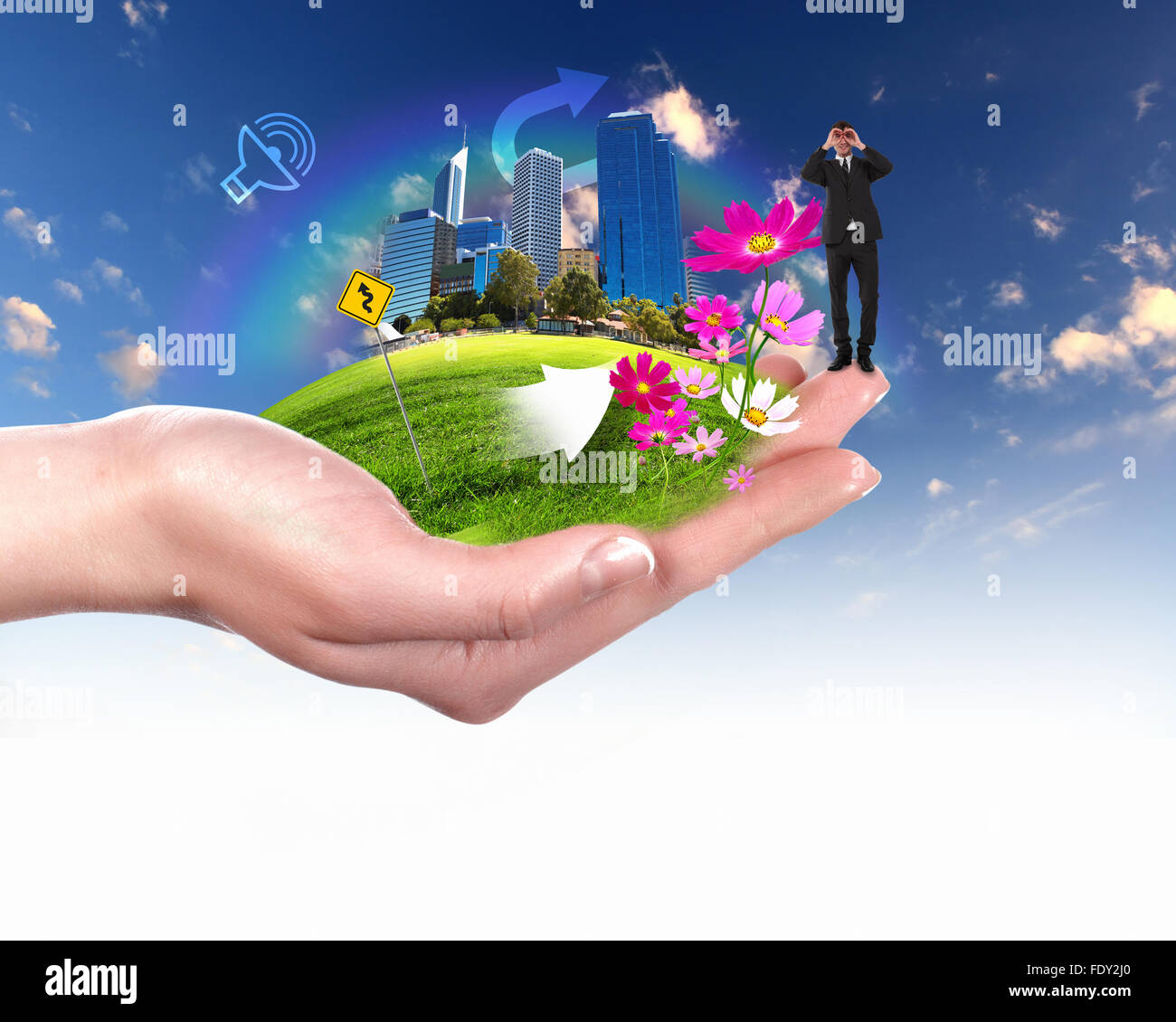 Collage with a human hand holding a green landscape Stock Photo - Alamy
