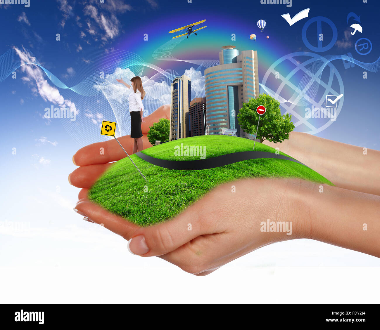 Collage with a human hand holding a green landscape Stock Photo - Alamy