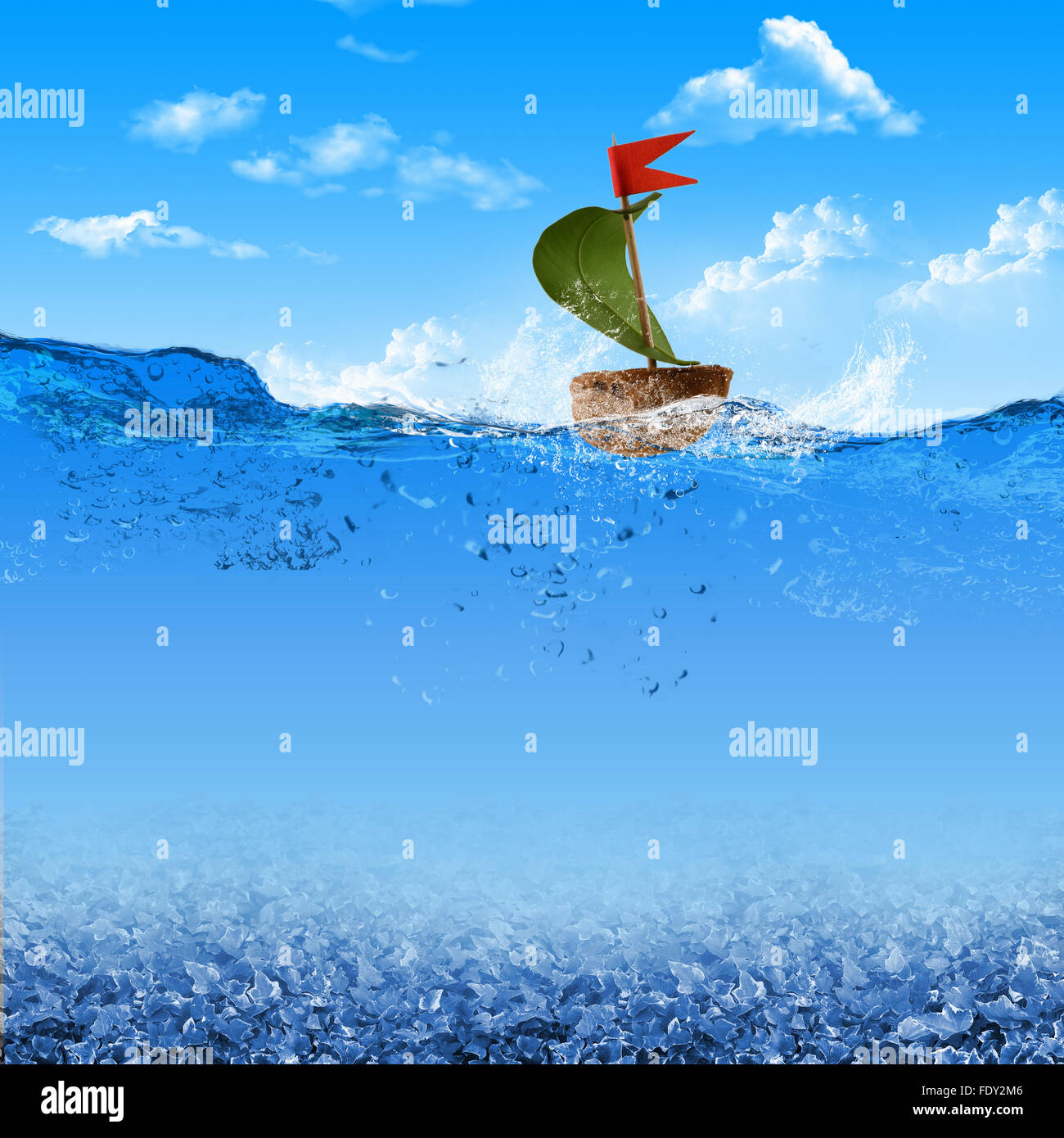 Nutshell ship with green leaf sail and red flag Stock Photo - Alamy