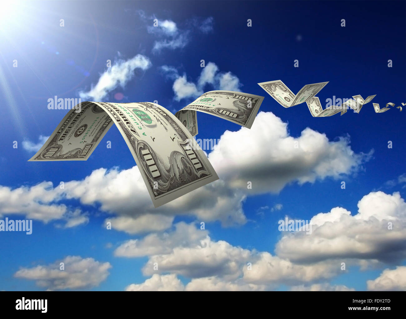 Dollar bills fly in flocks in the sky against a background of white ...