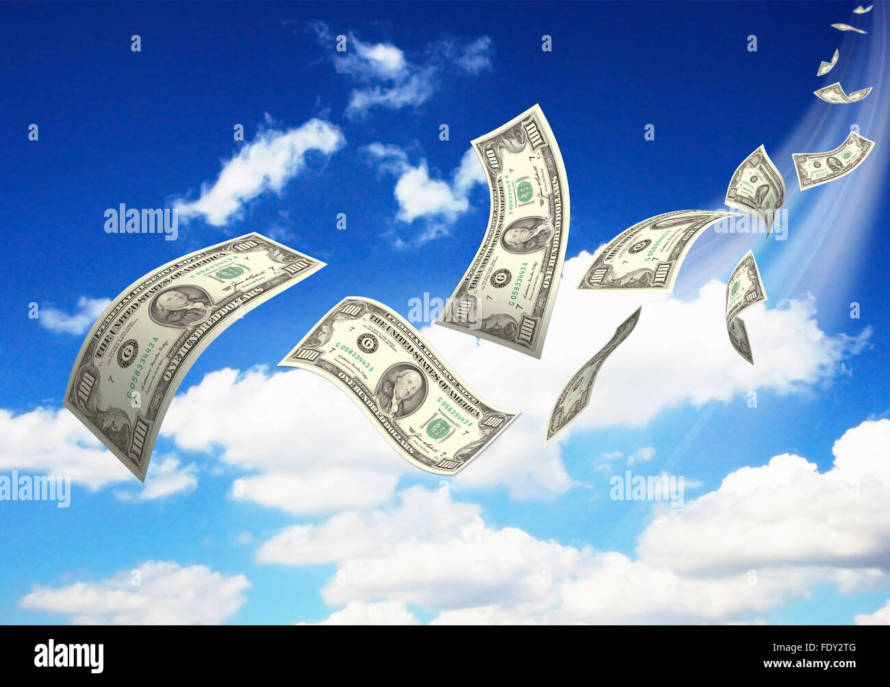 Dollar bills fly in flocks in the sky against a background of white ...
