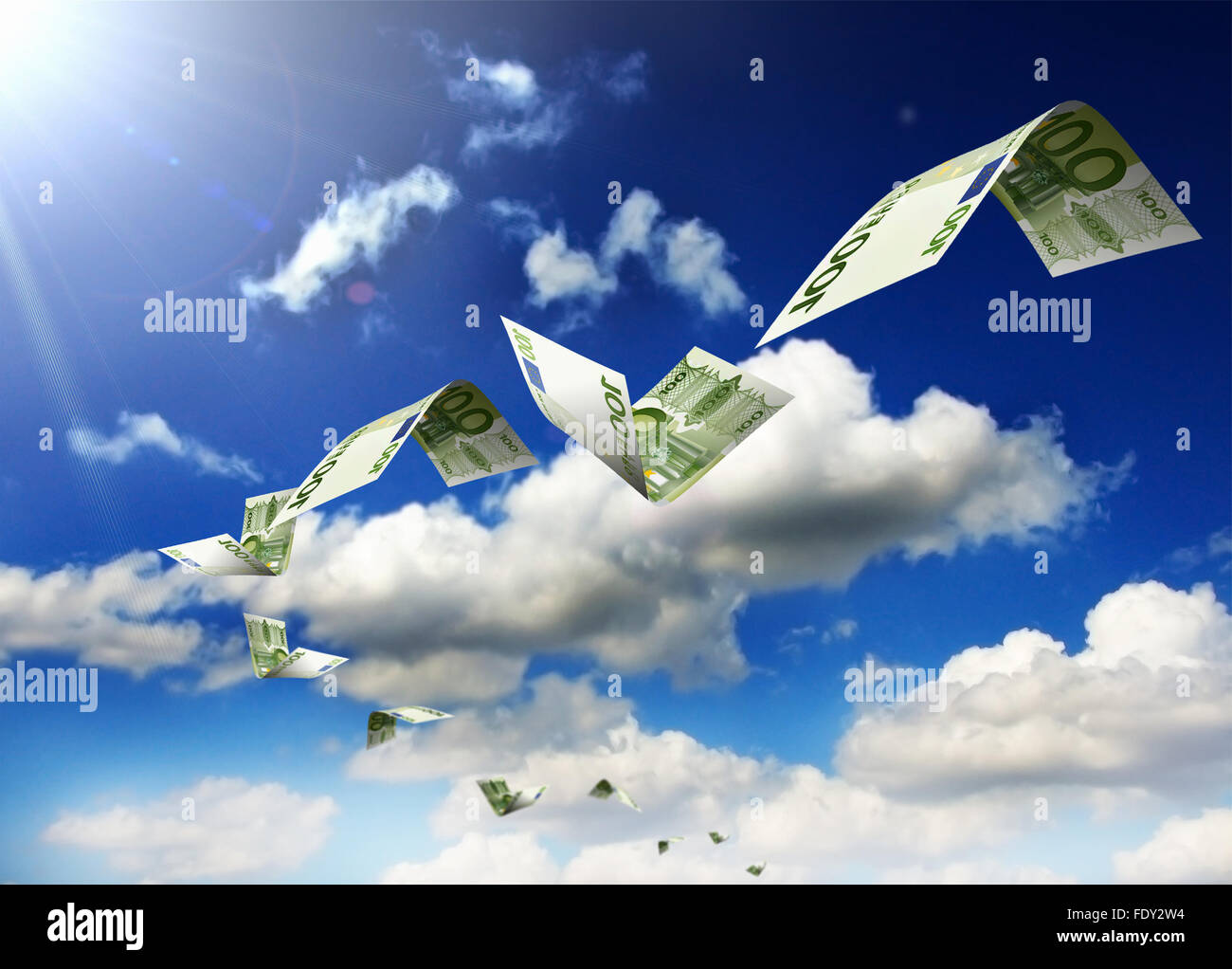 Dollar bills fly in flocks in the sky against a background of white ...
