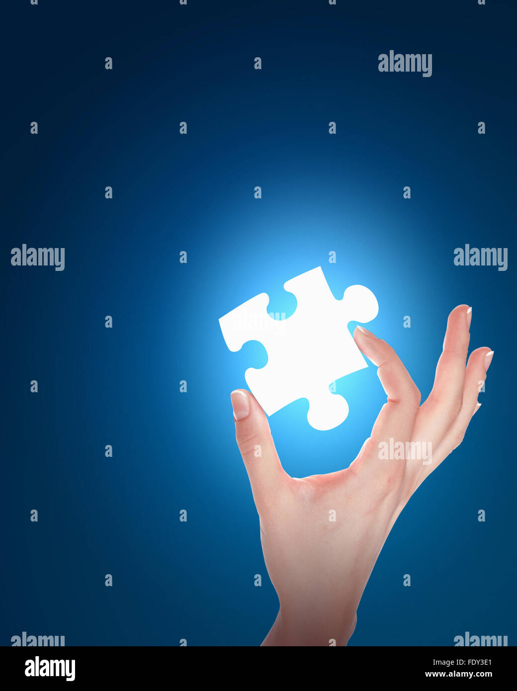 Human hand with a blue shining piece of puzzle hi-res stock photography ...