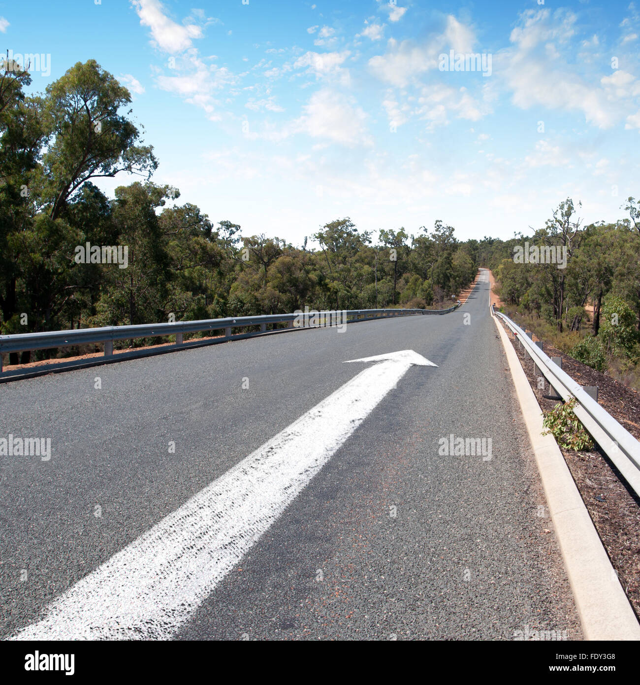 Empty countryside road with white arrow sing on it Stock Photo - Alamy