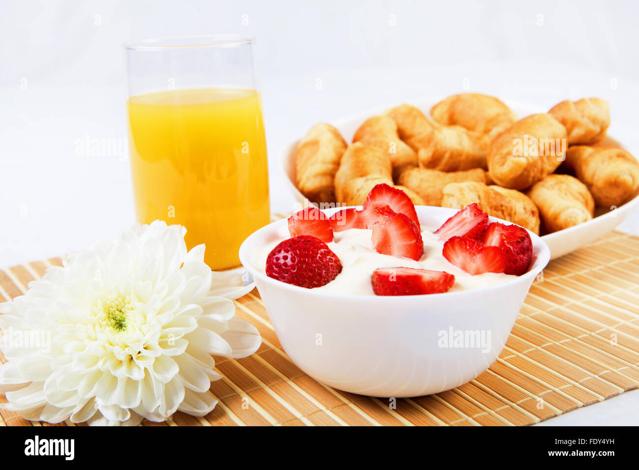 Early breakfast. Strawberries, cream and juice. The symbol of healthy ...