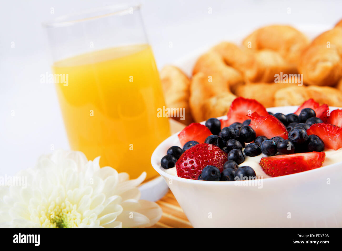 Early breakfast. Strawberries, cream and juice. The symbol of healthy ...