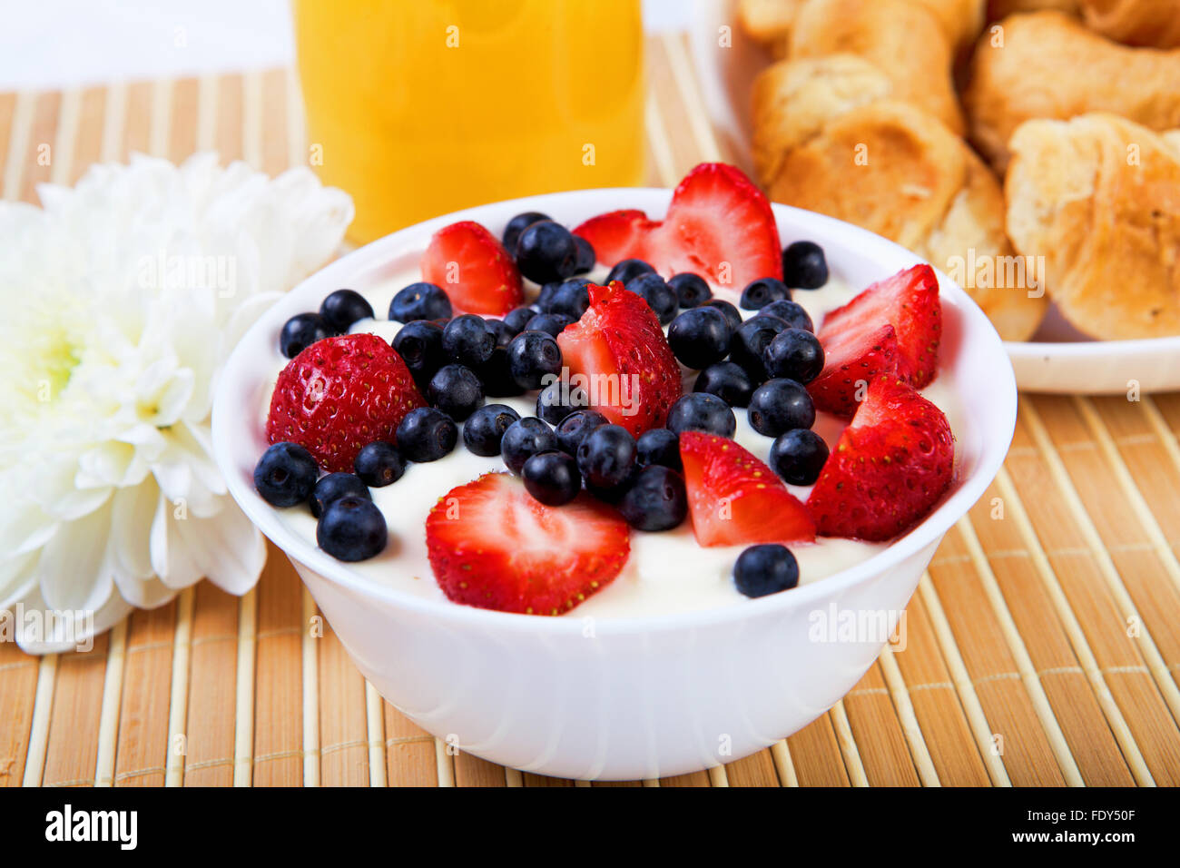 Early breakfast. Strawberries, cream and juice. The symbol of healthy ...