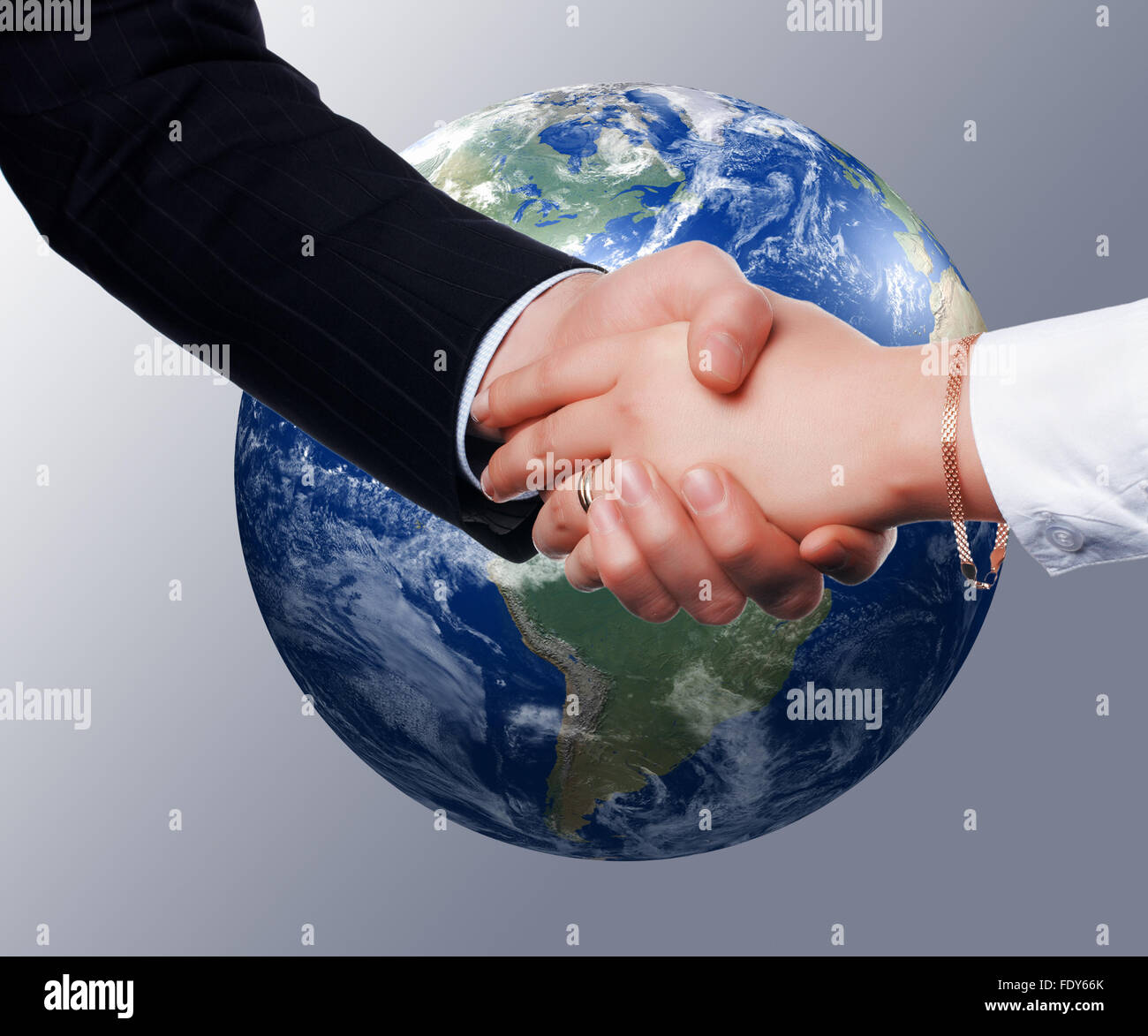 Business handshake on the background of the Earth. The symbol of a ...
