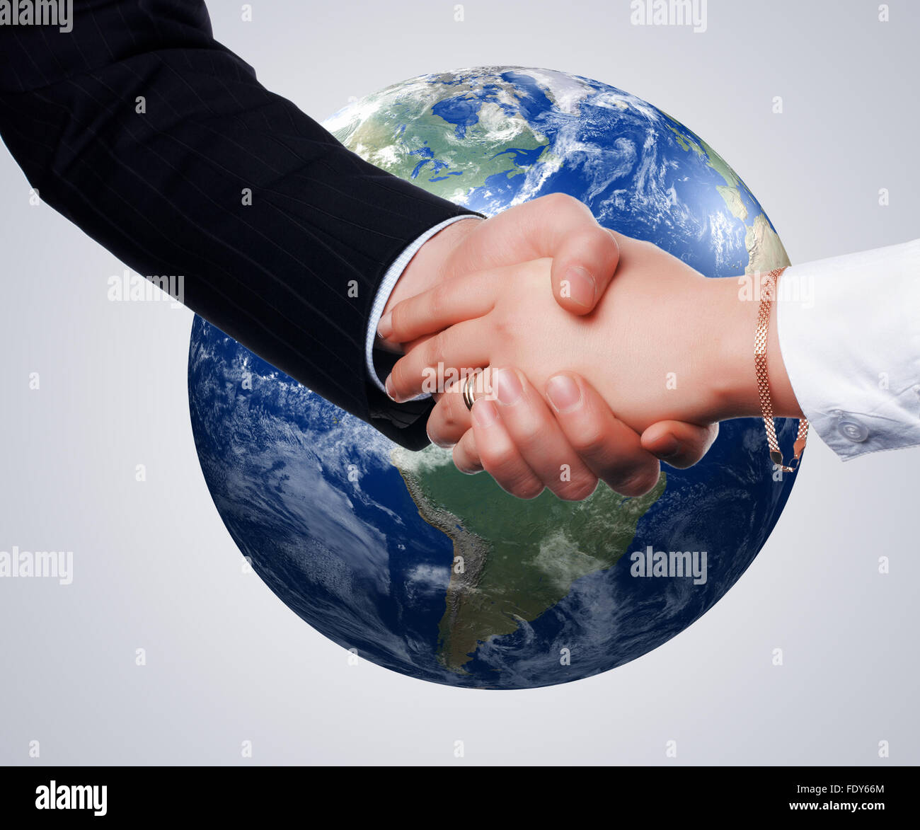 Business handshake on the background of the Earth. The symbol of a ...