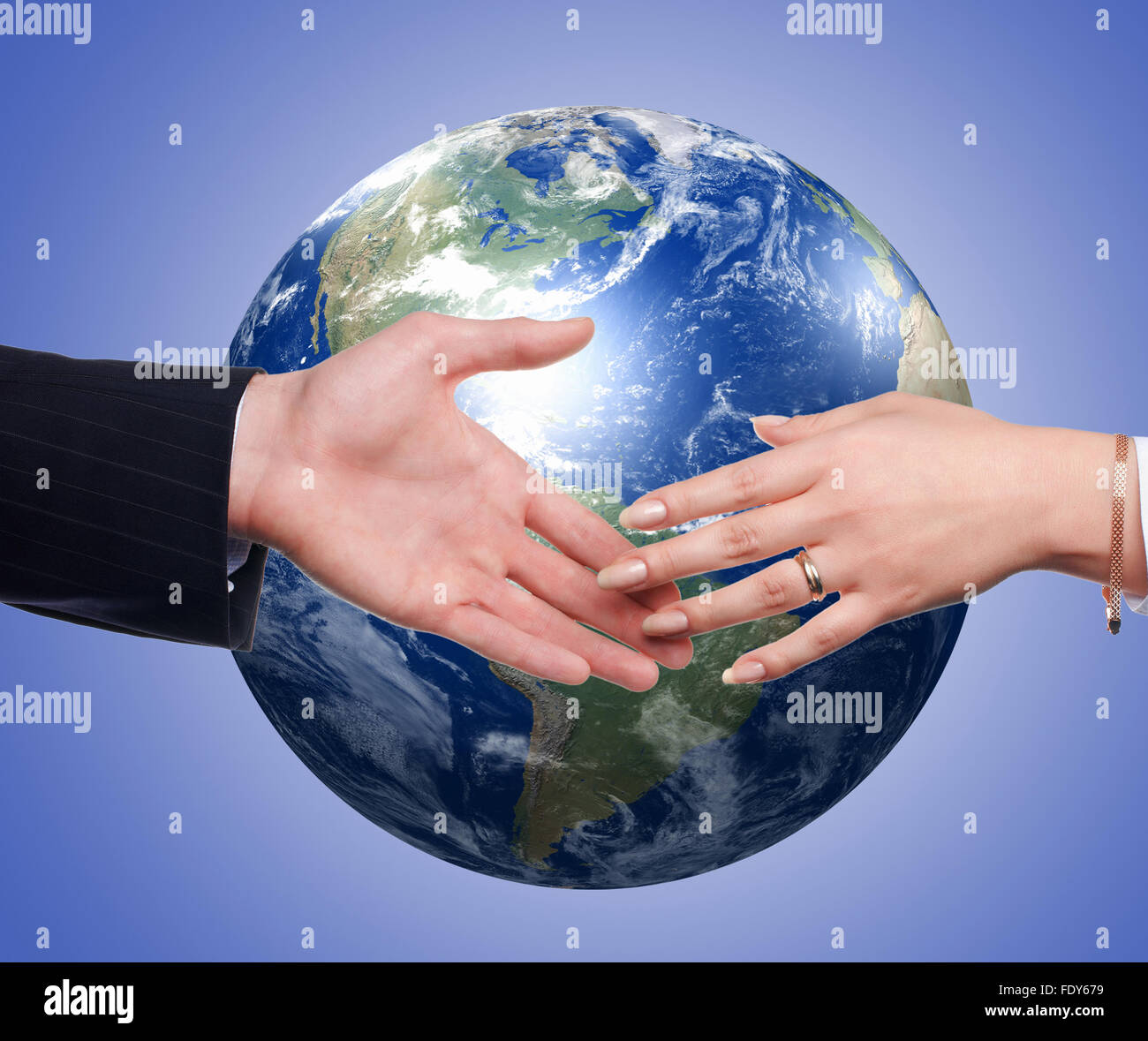 Business handshake on the background of the Earth. The symbol of a ...