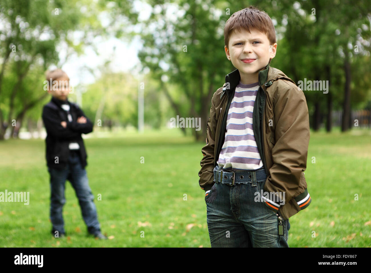 Happy smiling boy with a friend in the green park Stock Photo - Alamy