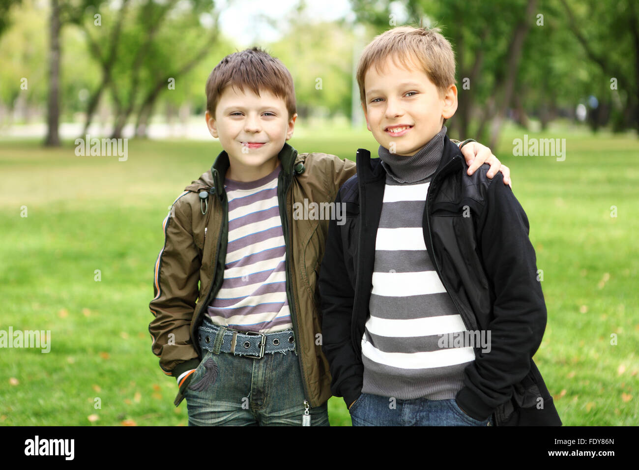 Happy smiling boy with a friend in the green park Stock Photo - Alamy