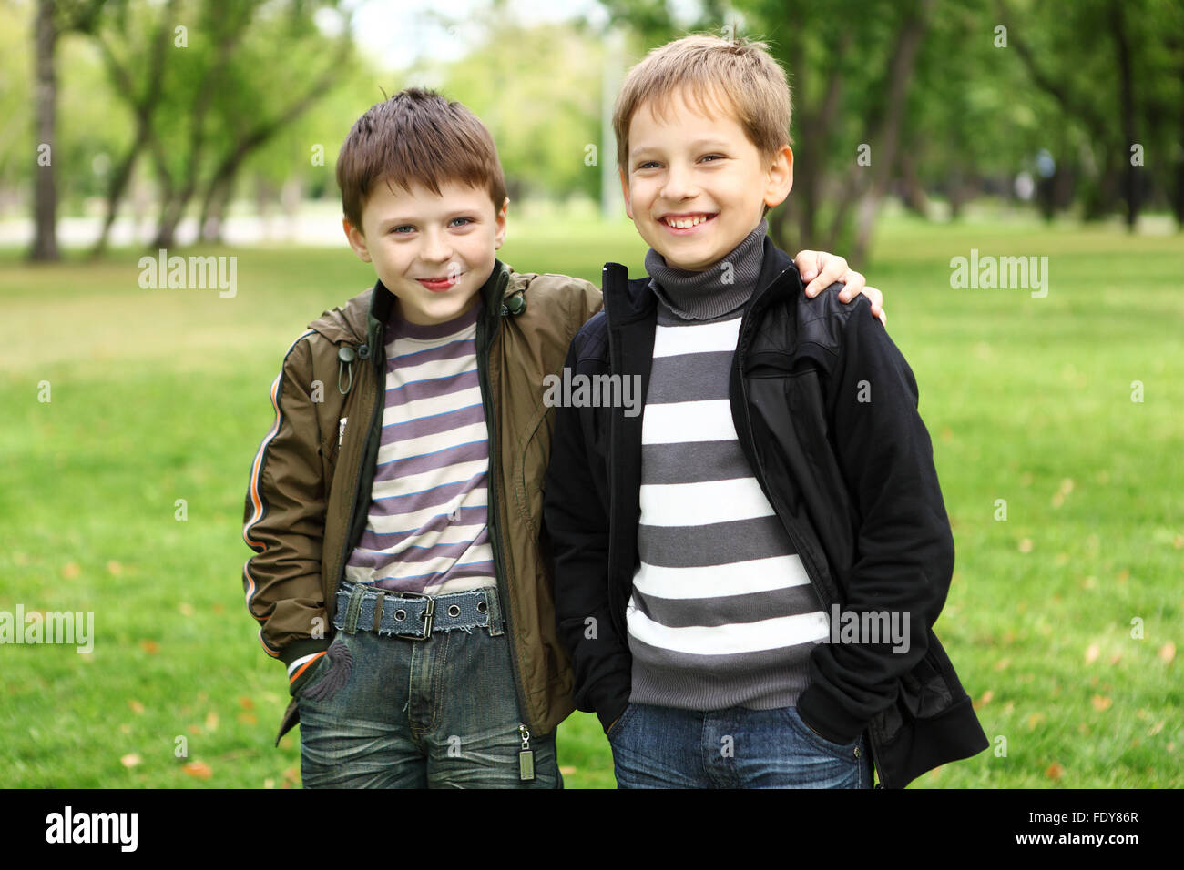 Happy smiling boy with a friend in the green park Stock Photo - Alamy