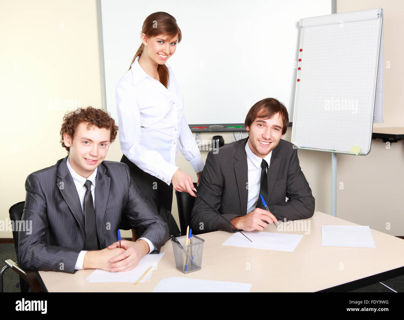 three collegues in an office discussing business Stock Photo - Alamy