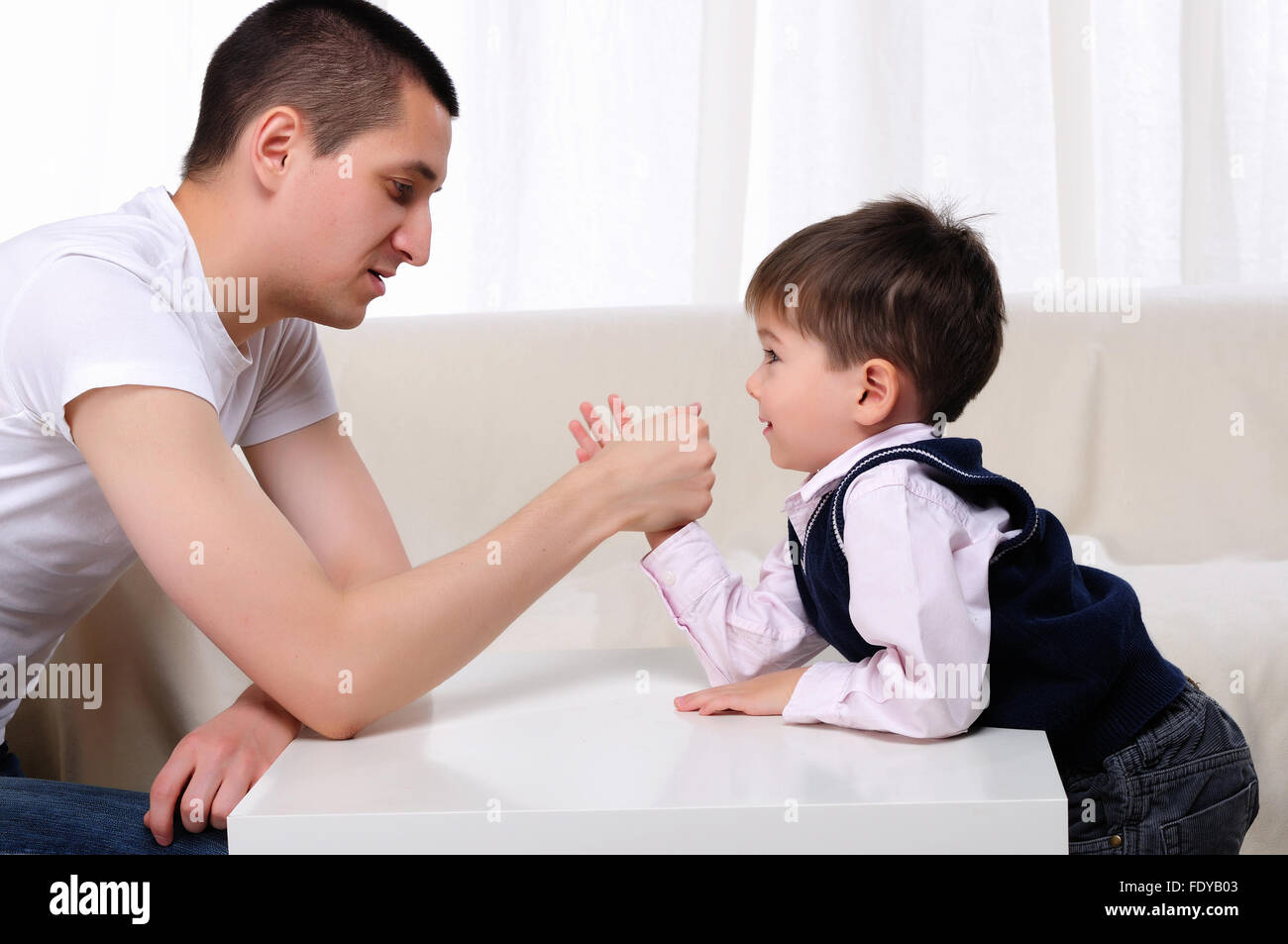 A young father and his young son struggling in the arms Stock Photo - Alamy