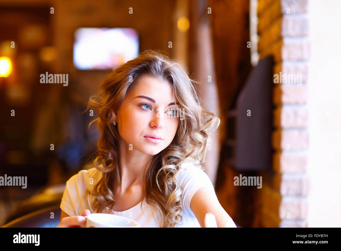 Portrait of young pretty woman sitting in restaurant Stock Photo - Alamy