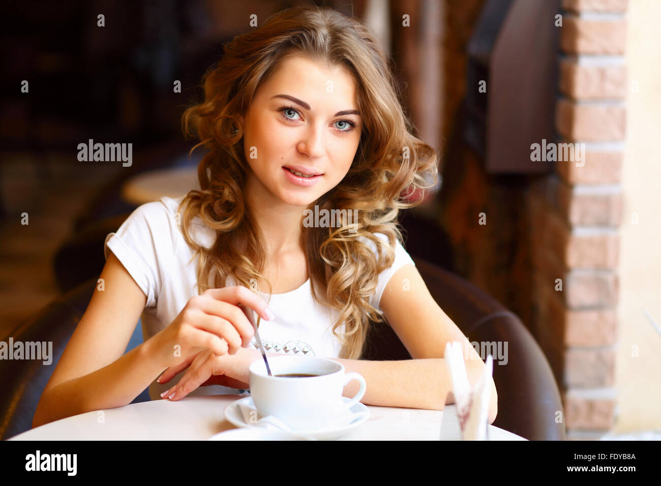 Portrait of young pretty woman sitting in restaurant Stock Photo - Alamy