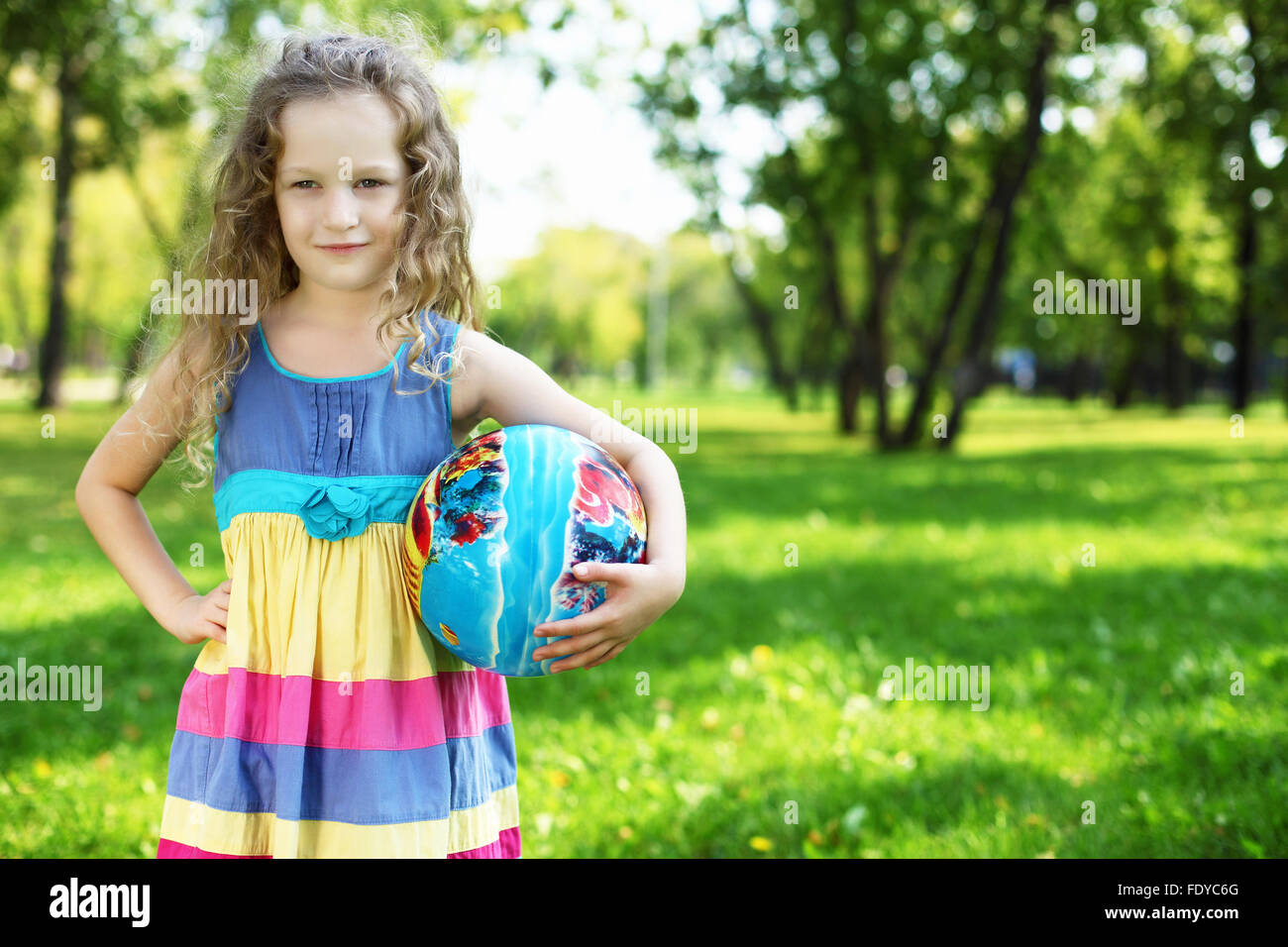 Little happy girl having fun in green summer park Stock Photo - Alamy