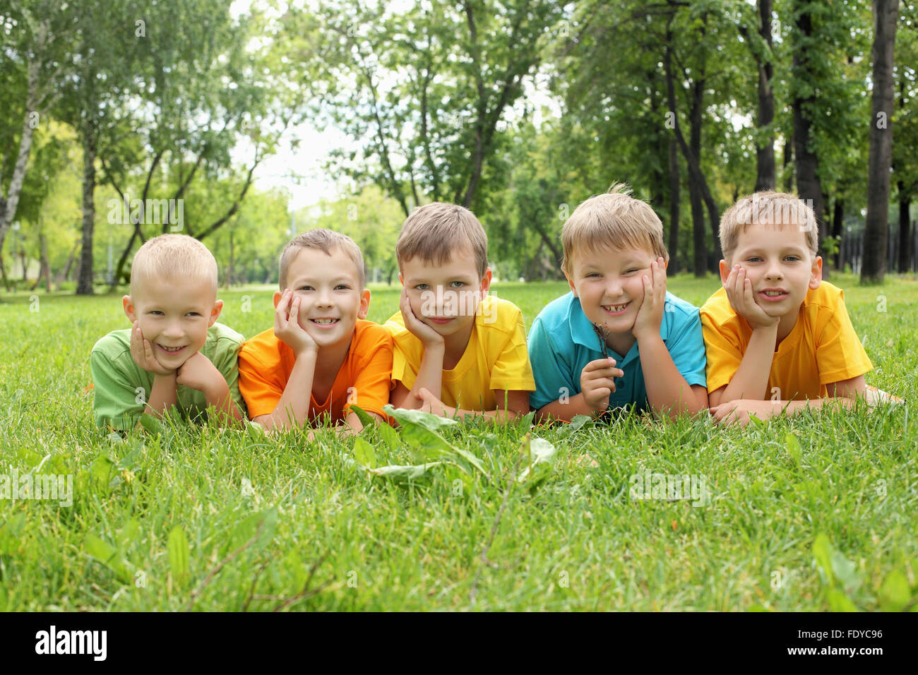 Group children lying on grass hi-res stock photography and images - Alamy
