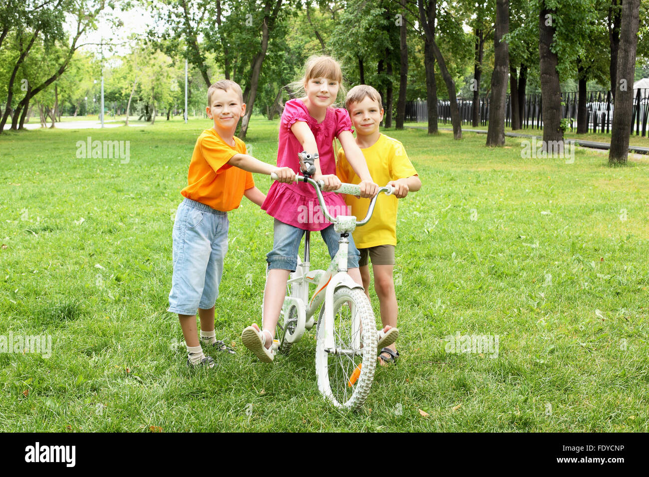 Girls with a bike in the summer park Stock Photo - Alamy