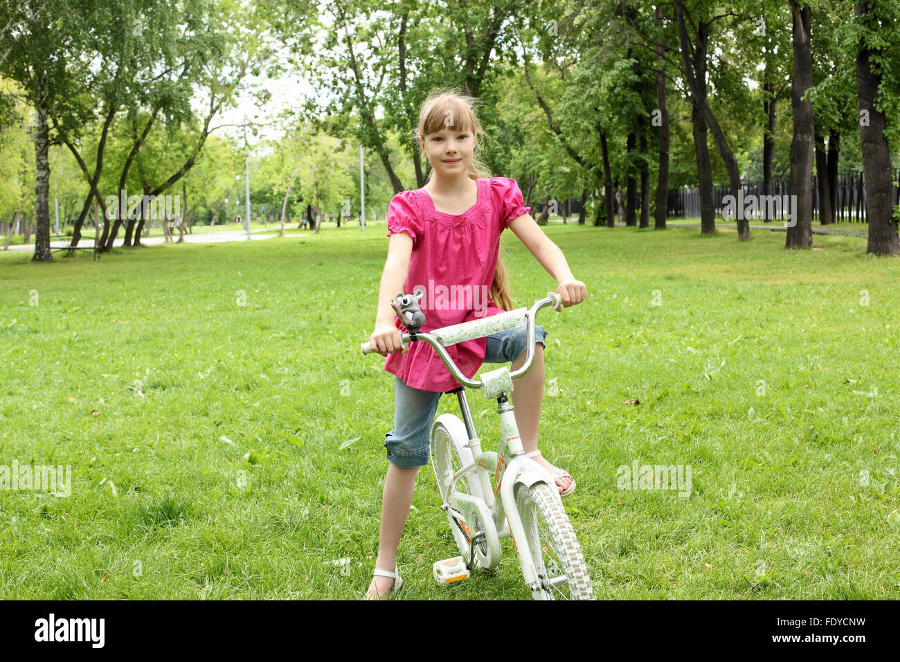Girl with a bike in the summer park Stock Photo - Alamy