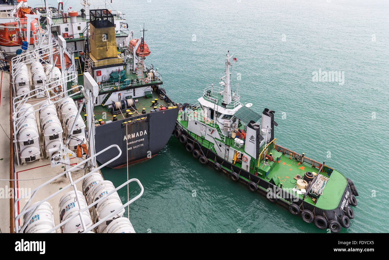A tug and fuel tender refuel a cruise ship in Singapore Stock Photo - Alamy