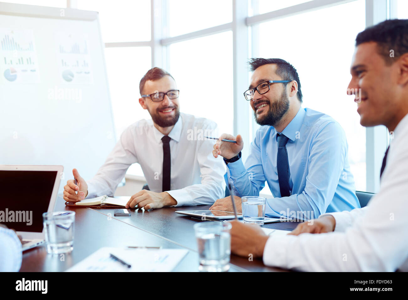 Group of young managers sharing and discussing their ideas Stock Photo ...