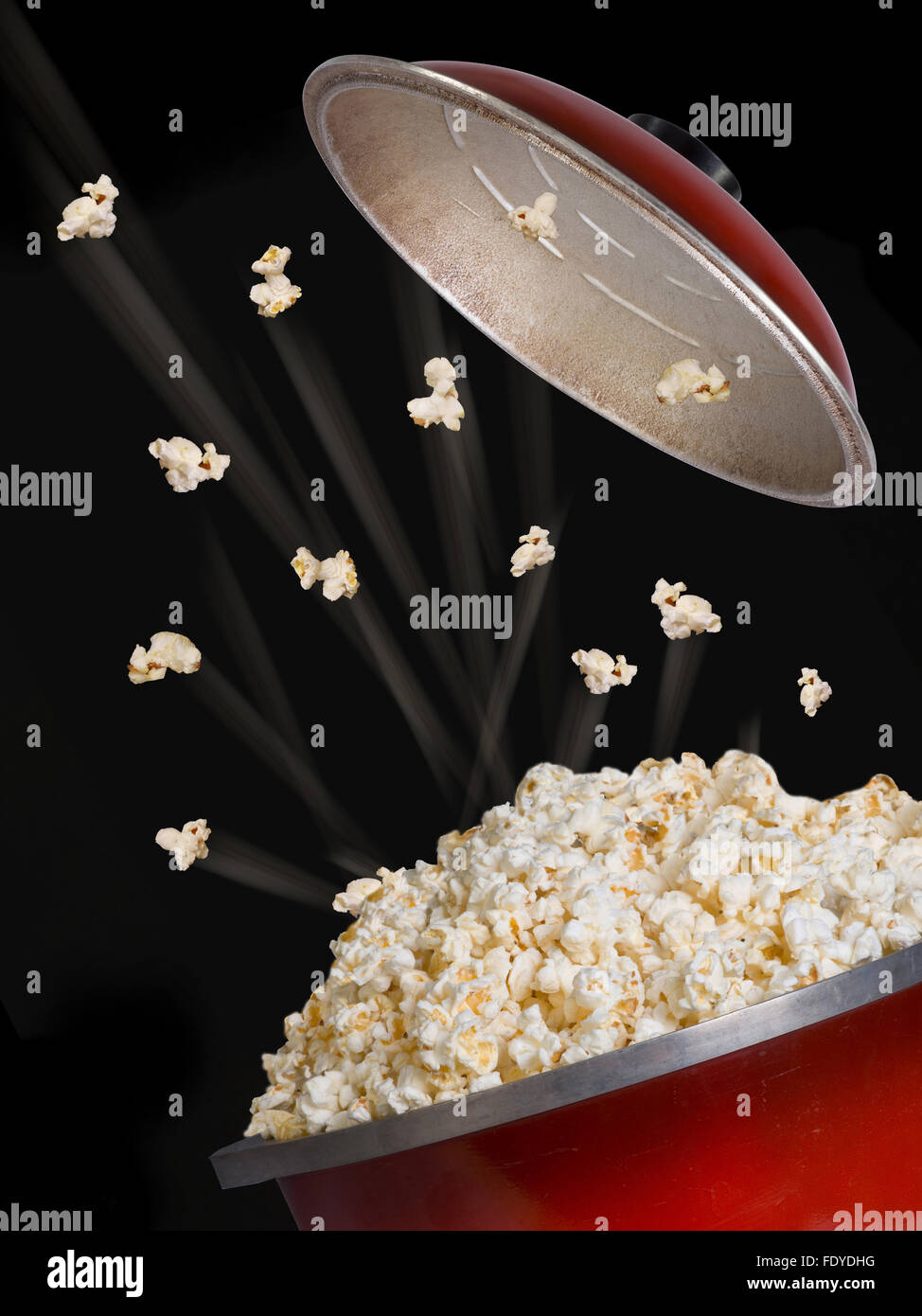 Popcorn flying and exploding from red kettle Stock Photo - Alamy