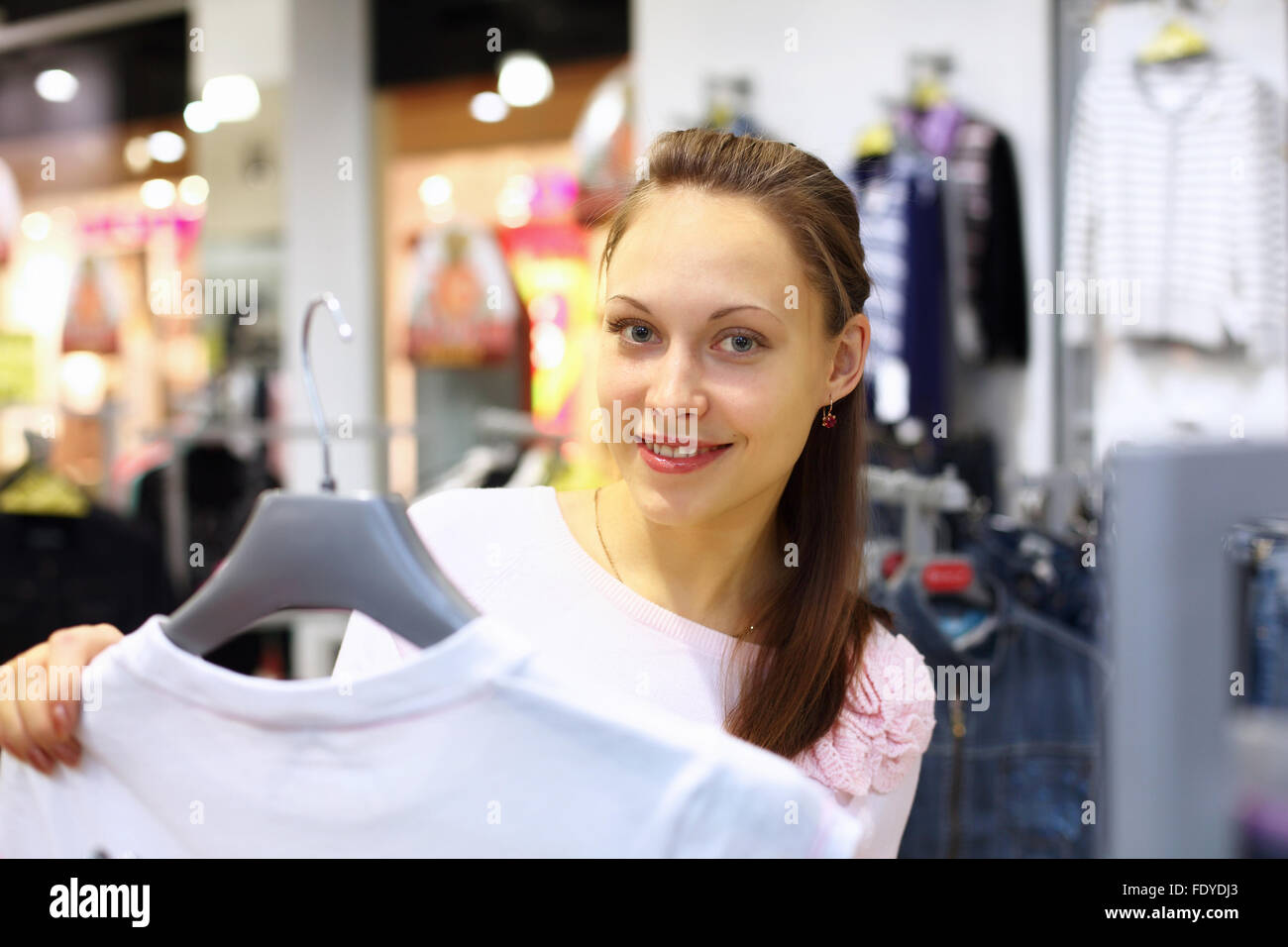Young woman doing shopping in clothes store Stock Photo - Alamy