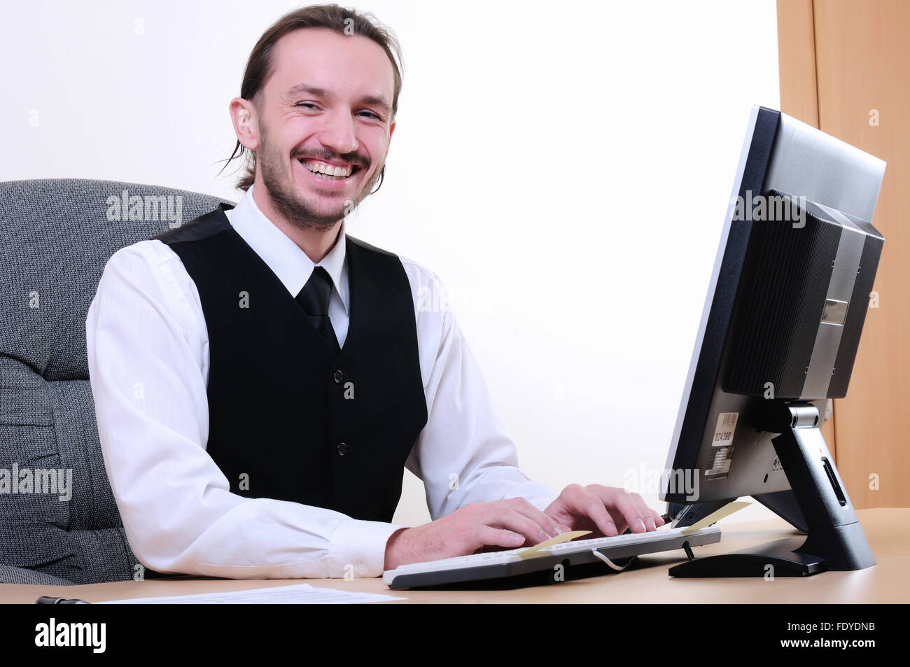 A young business man working on the computer in the office Stock Photo ...