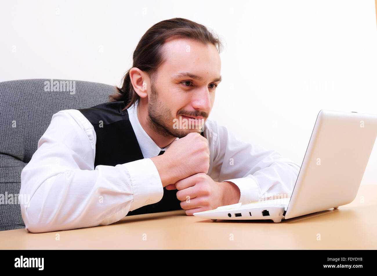 A young business man working on the computer in the office Stock Photo ...