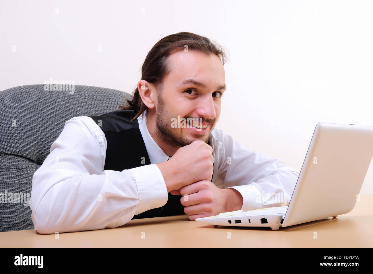 A young business man working on the computer in the office Stock Photo ...