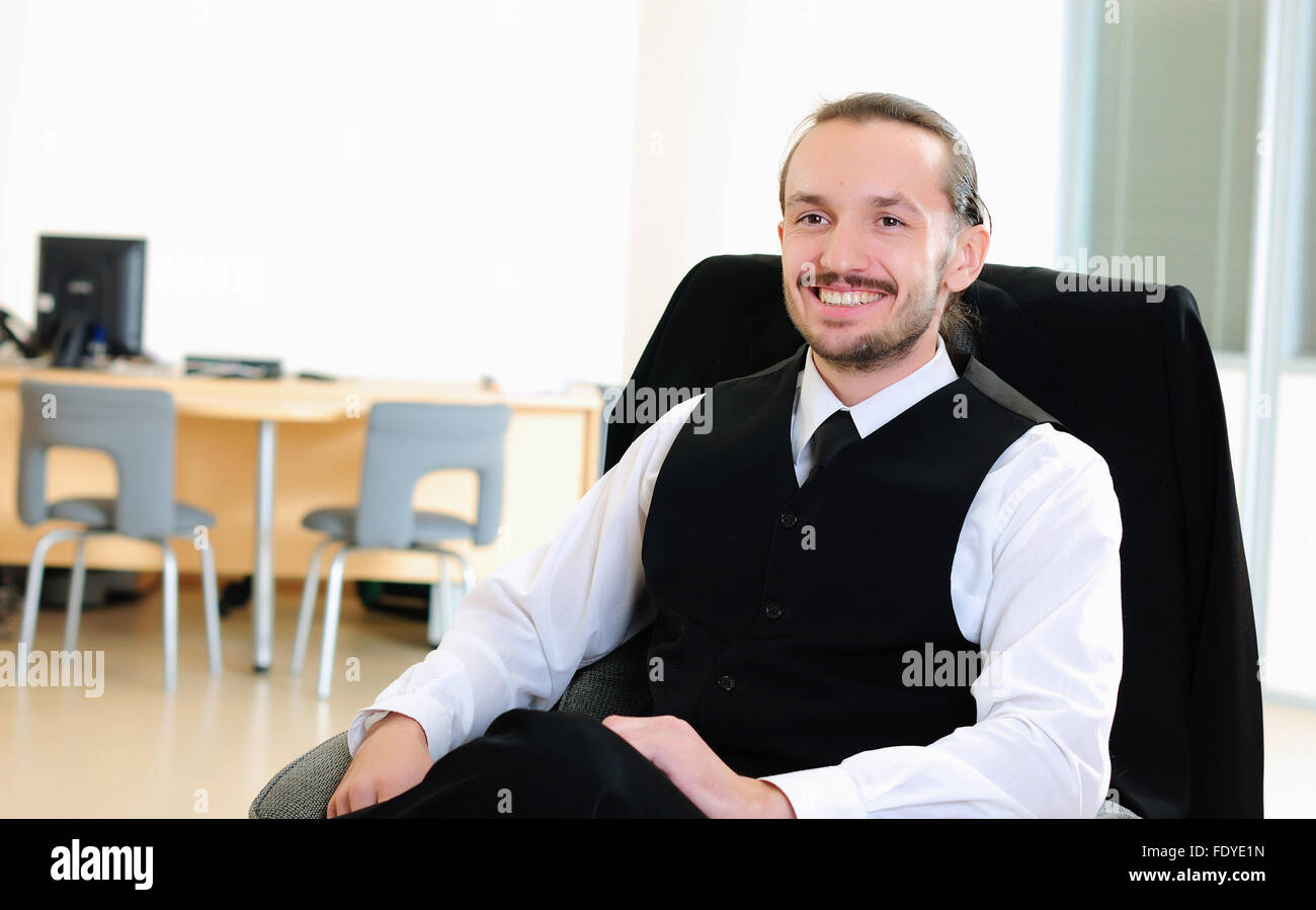 A business man in his office rests in the chair Stock Photo - Alamy