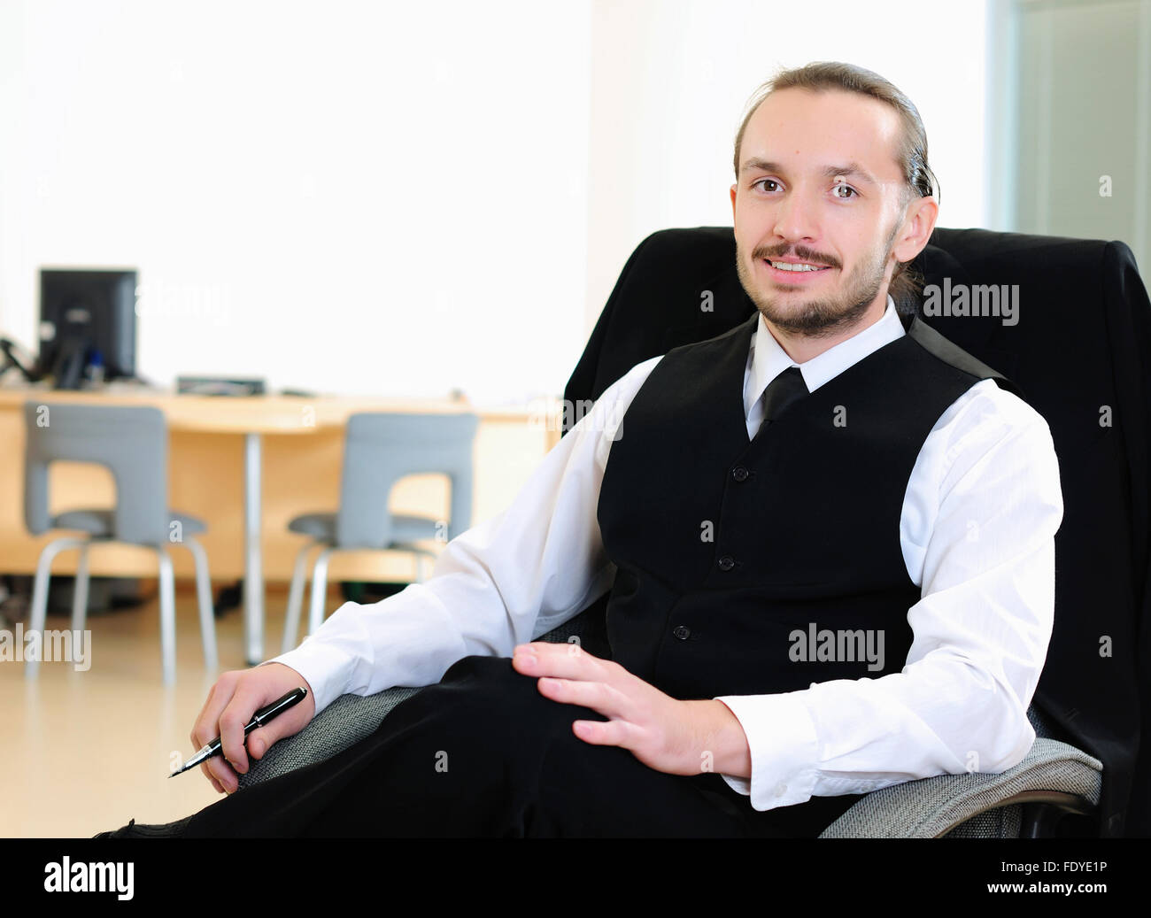 A business man in his office rests in the chair Stock Photo - Alamy
