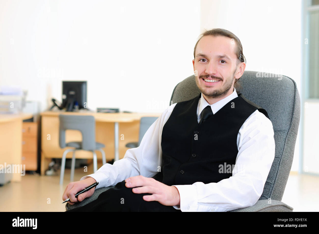 A business man in his office rests in the chair Stock Photo - Alamy