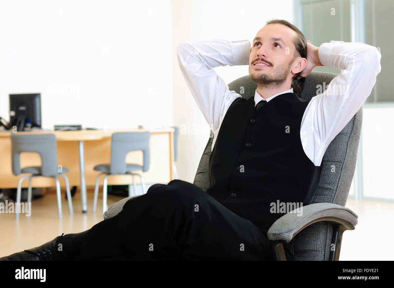 A business man in his office rests in the chair Stock Photo - Alamy