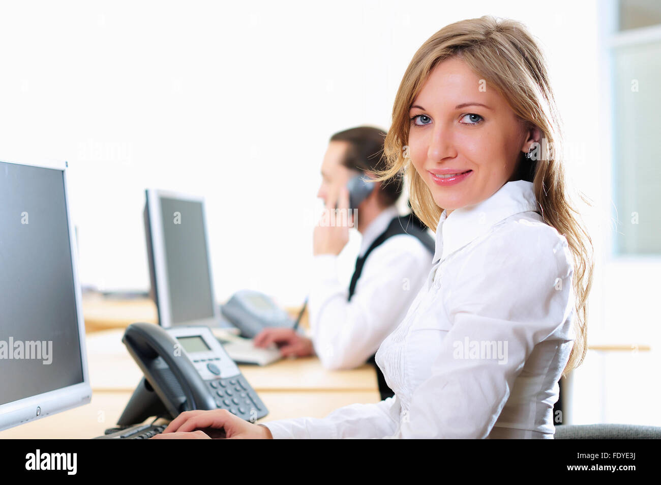A young girl in his office at his workplace works at the computer Stock ...