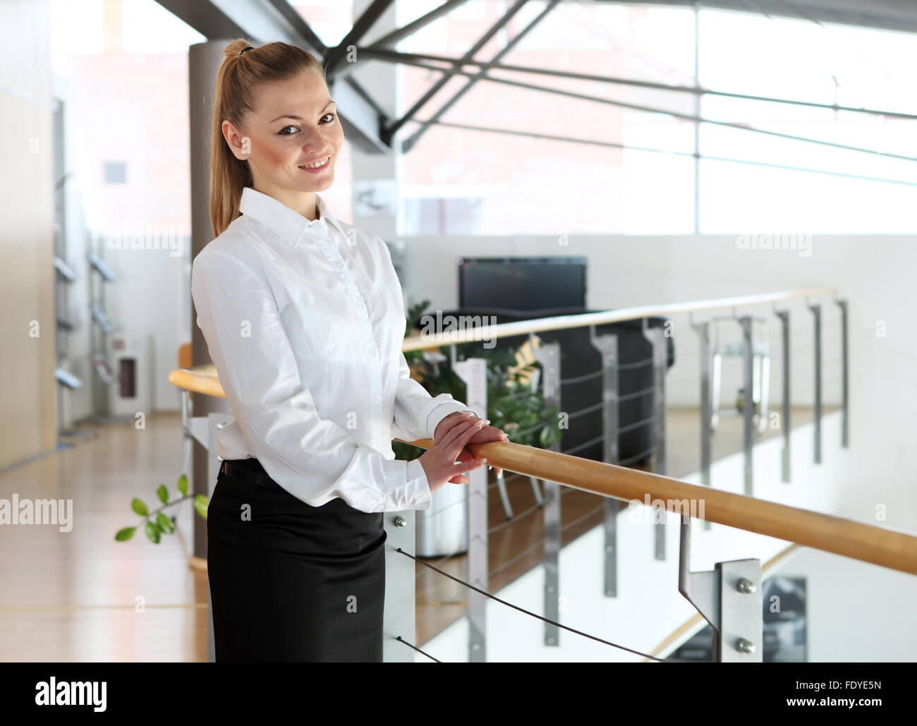 portrait of a young pretty woman standing inside office building Stock ...