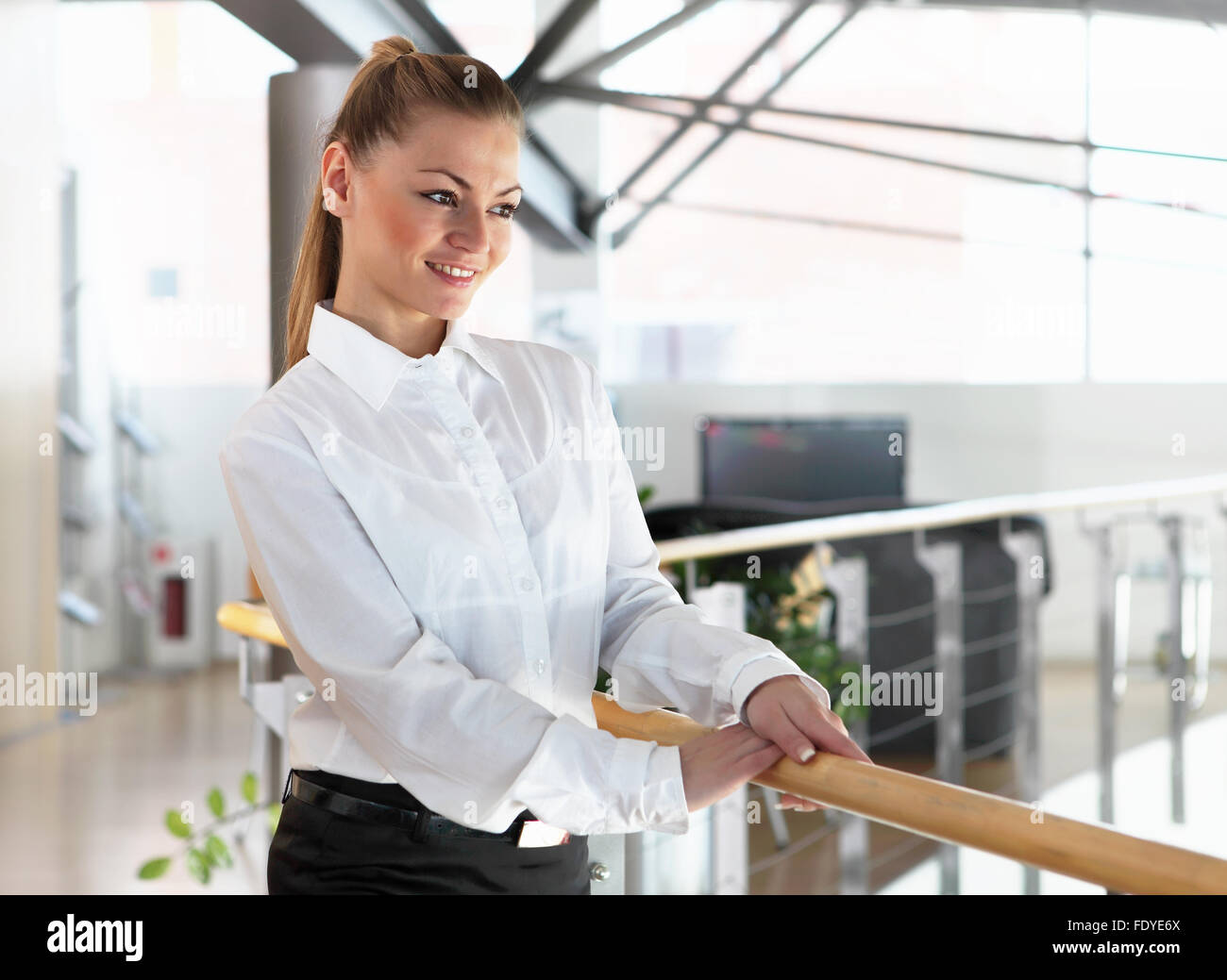 portrait of a young pretty woman standing inside office building Stock ...