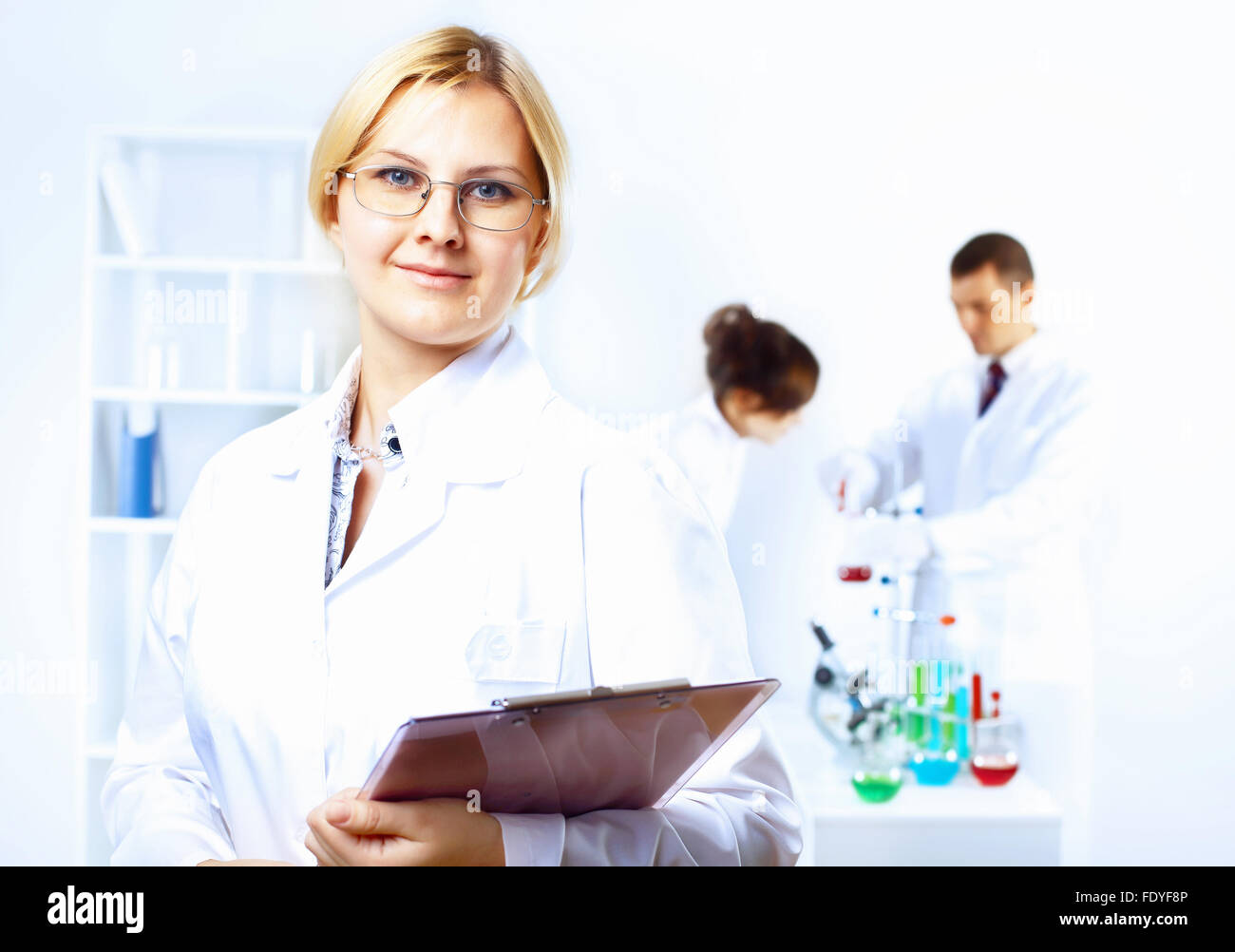 Scientist in uniform doing tests in laboratory Stock Photo - Alamy