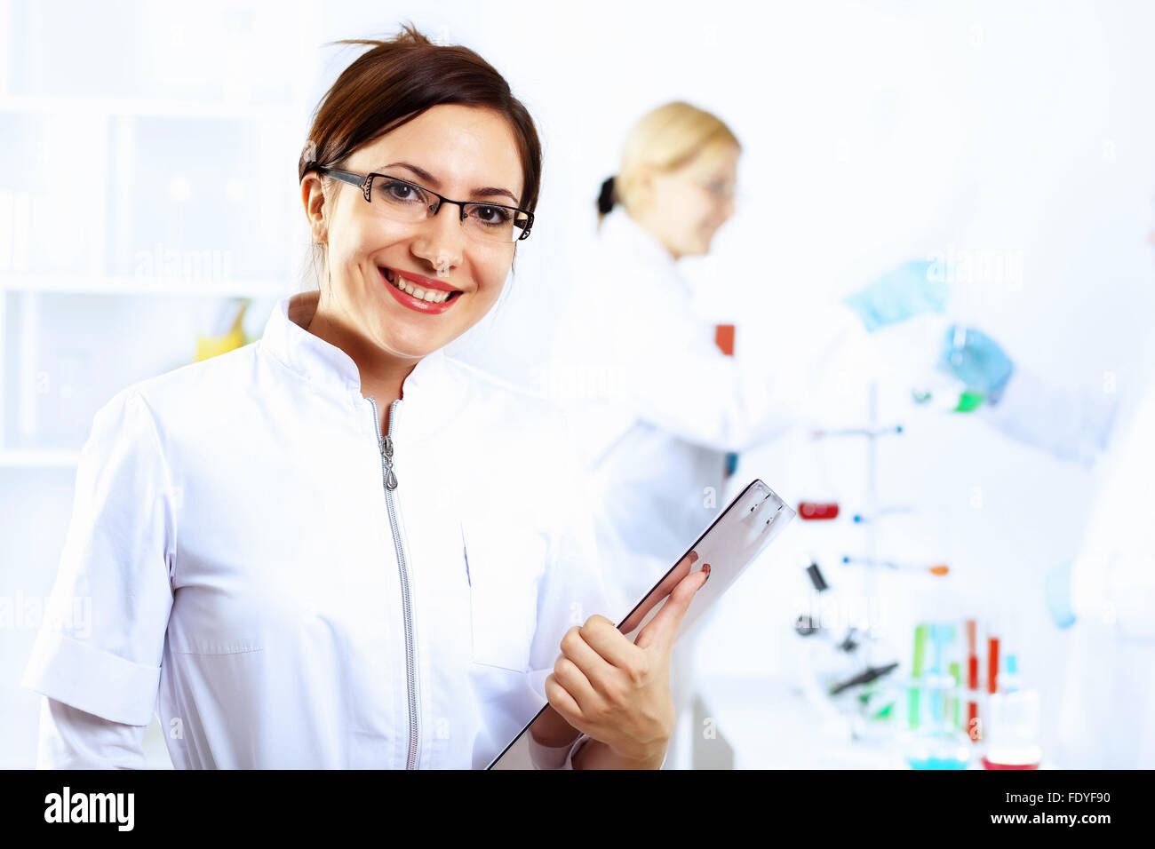 Scientist in uniform doing tests in laboratory Stock Photo - Alamy