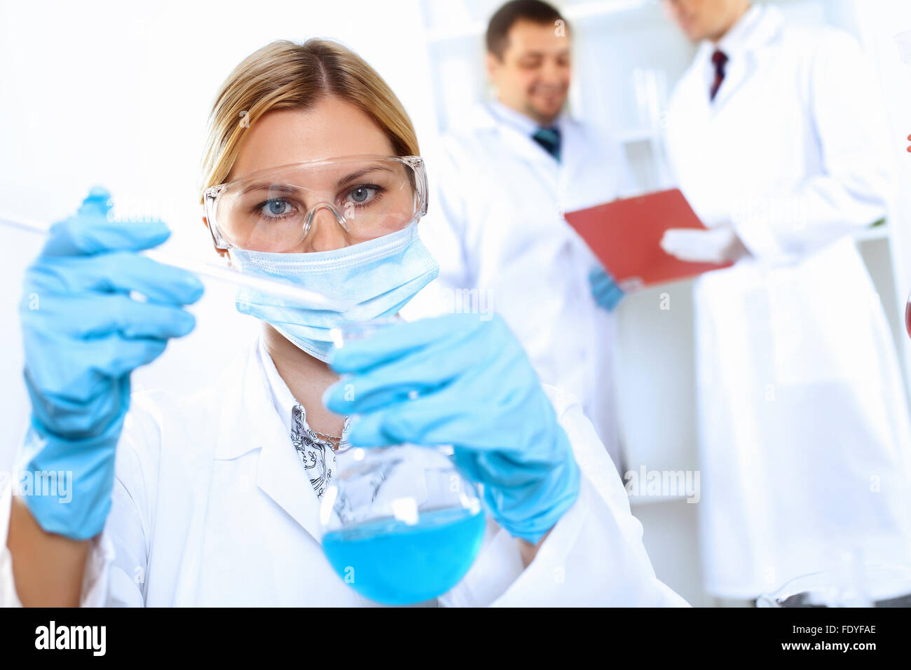 Scientist in uniform doing tests in laboratory Stock Photo - Alamy