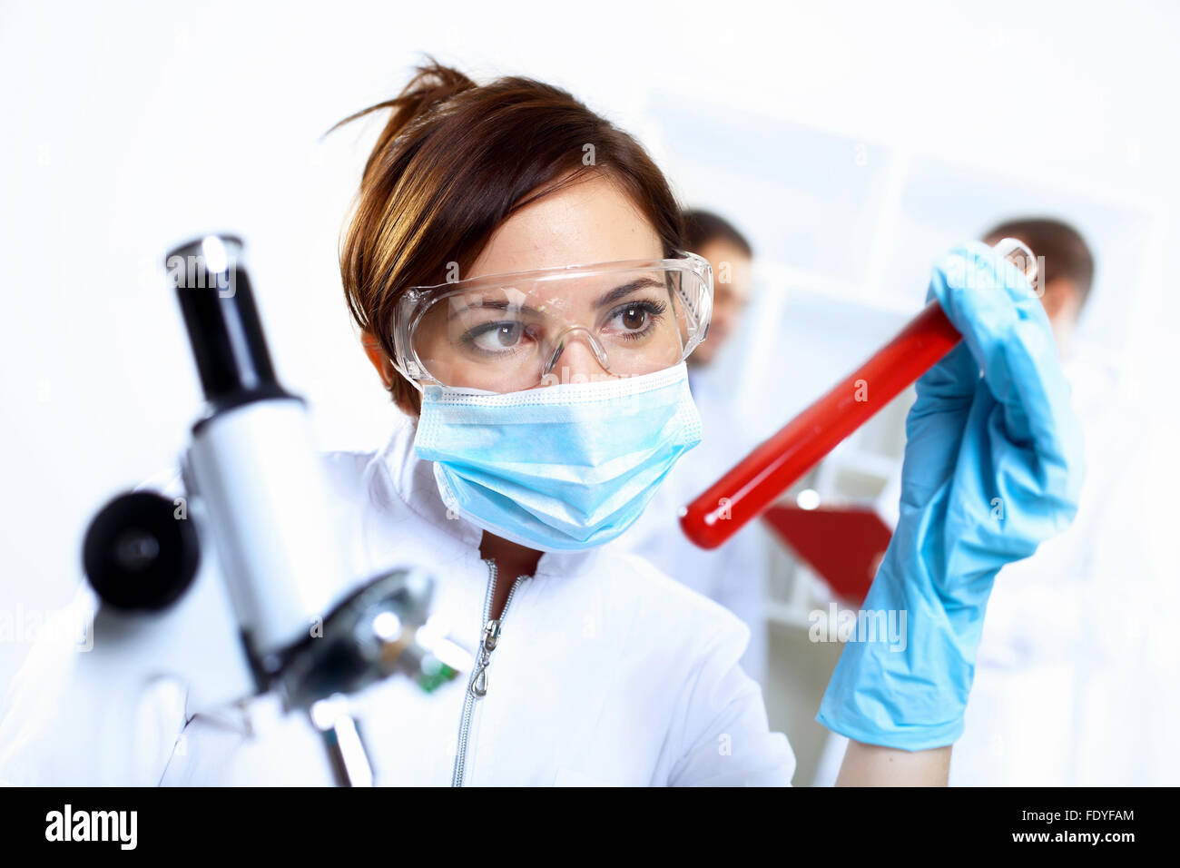 Scientist in uniform doing tests in laboratory Stock Photo - Alamy