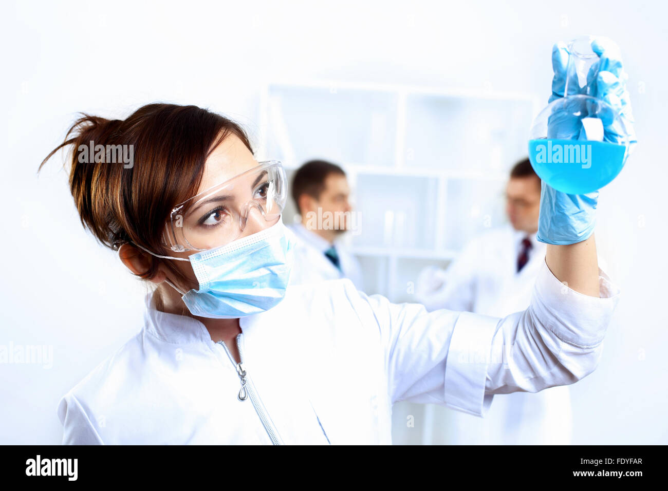 Scientist in uniform doing tests in laboratory Stock Photo - Alamy